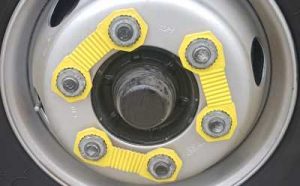 What are the yellow plastic indicators on truck and bus wheels?