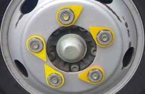 What are the yellow plastic indicators on truck and bus wheels?