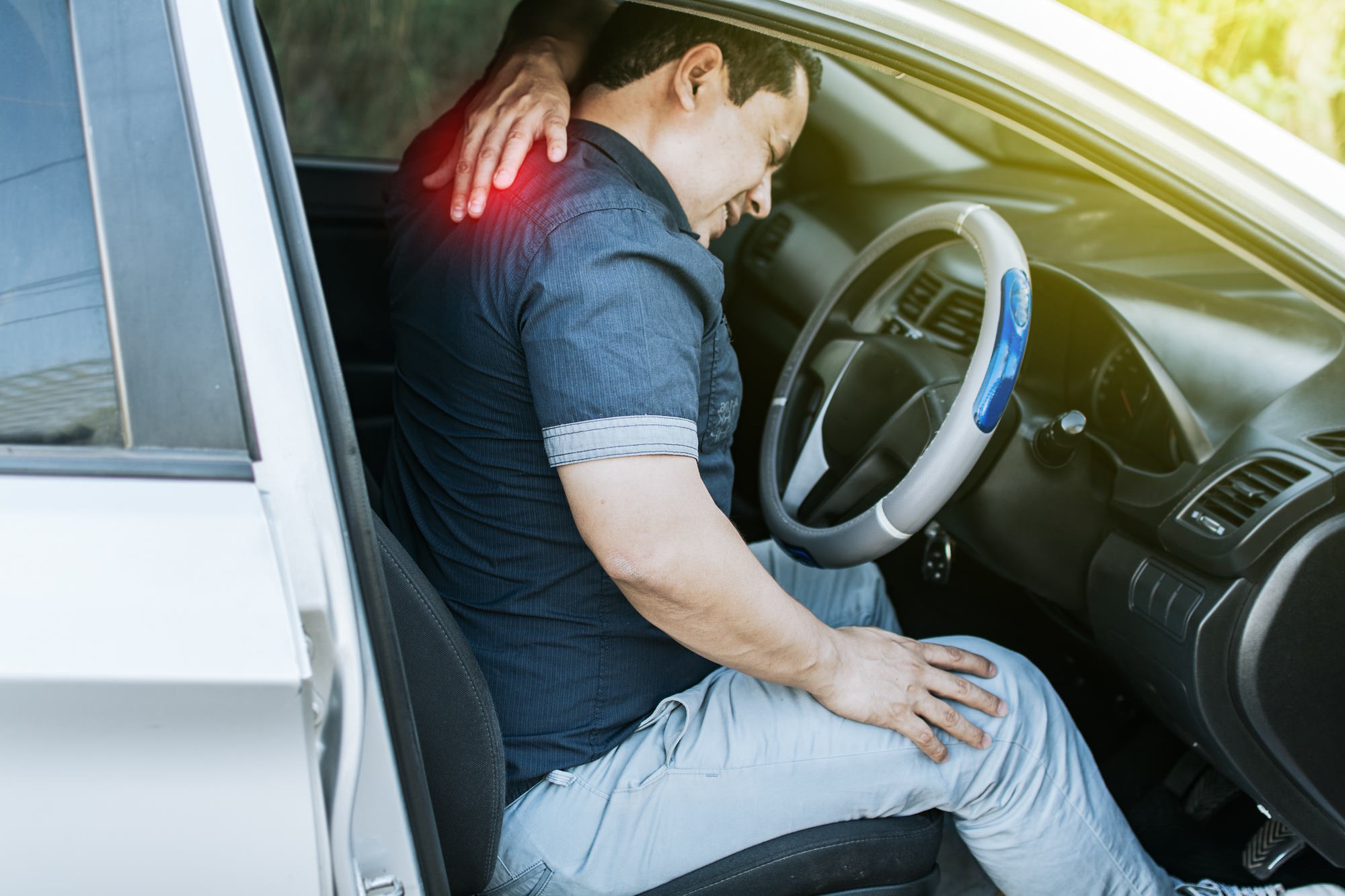 To reduce pain, what is the correct posture when driving?